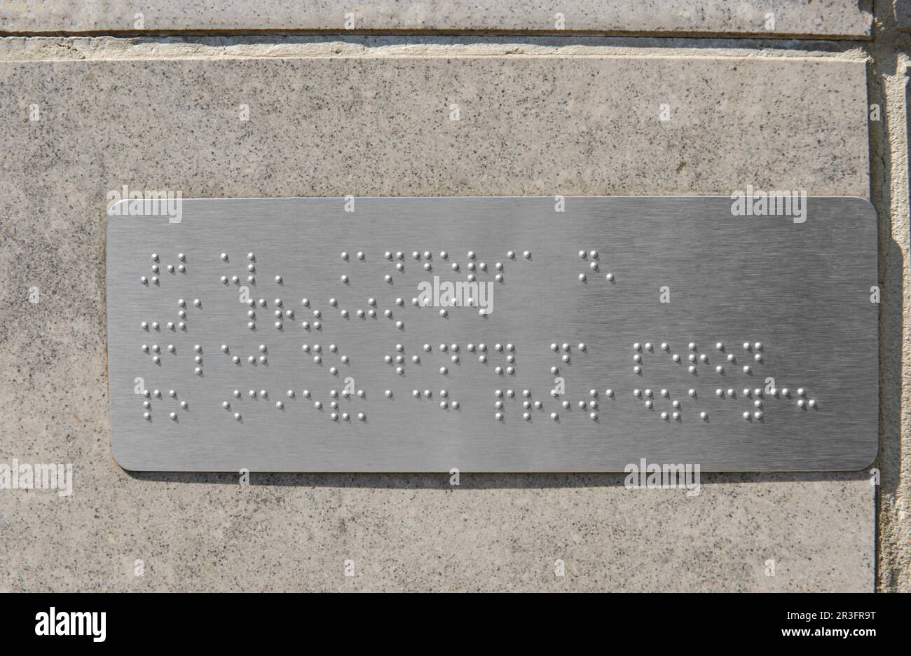Silver plate with Braille text on grey wall, closeup Stock Photo - Alamy