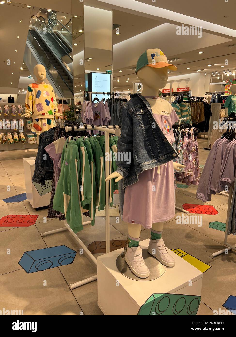 Beautiful children's clothes on mannequins and racks in fashion store ...