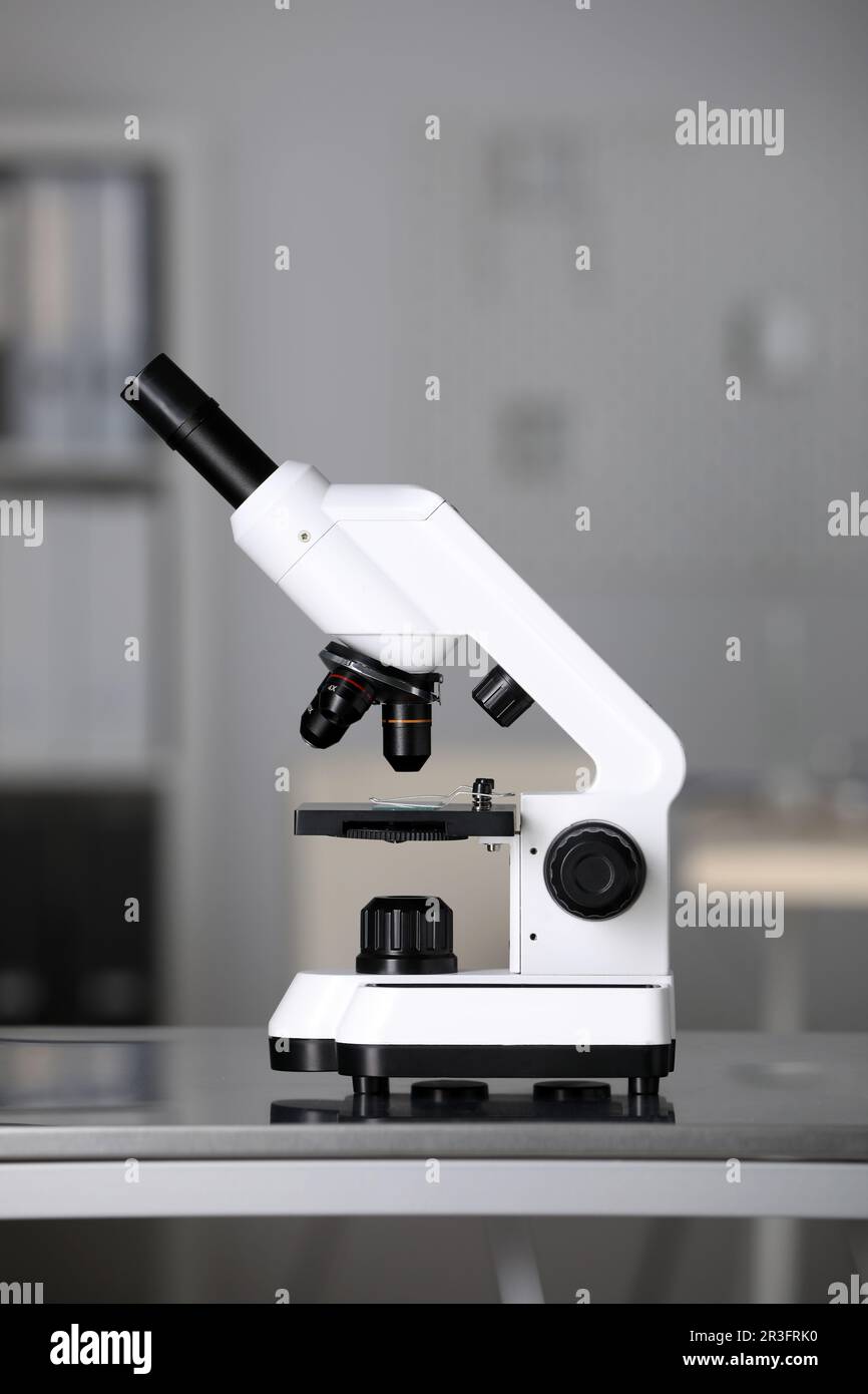 Modern medical microscope on metal table in laboratory Stock Photo - Alamy
