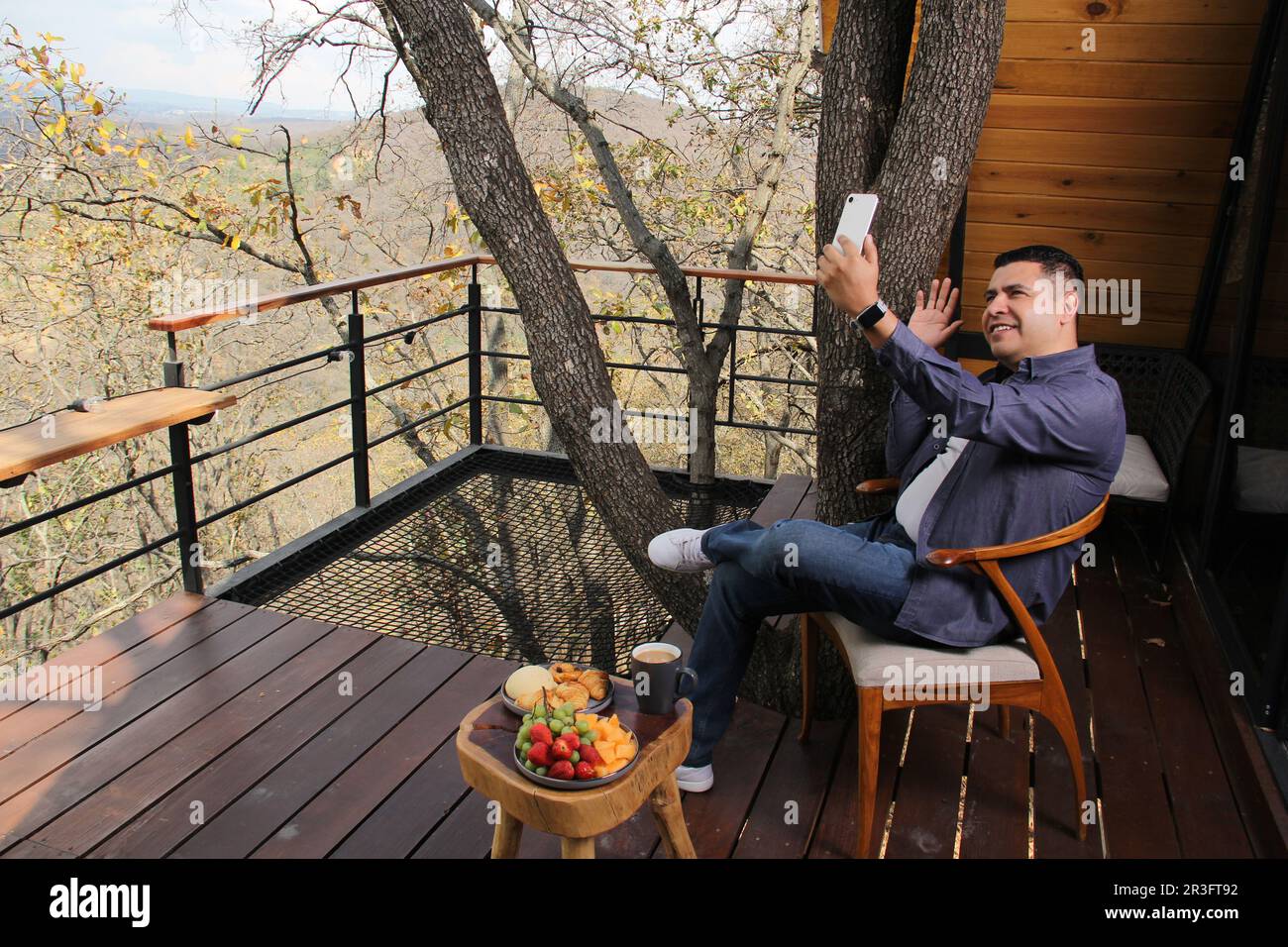 Dark-haired 40-year-old Latino adult man uses his cell phone for video ...