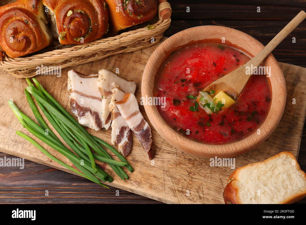 Delicious borsch served with pampushky and salo on wooden table, above ...