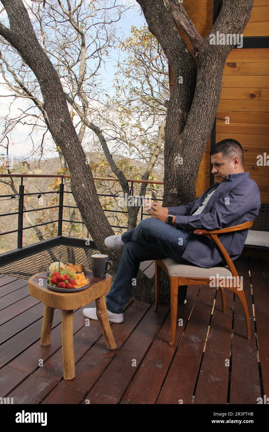 Dark-haired 40-year-old Latino adult man uses his cell phone for video ...