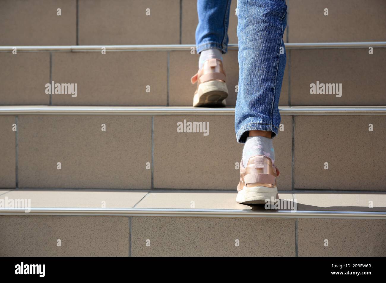 Woman walking up the stairs hi-res stock photography and images - Alamy