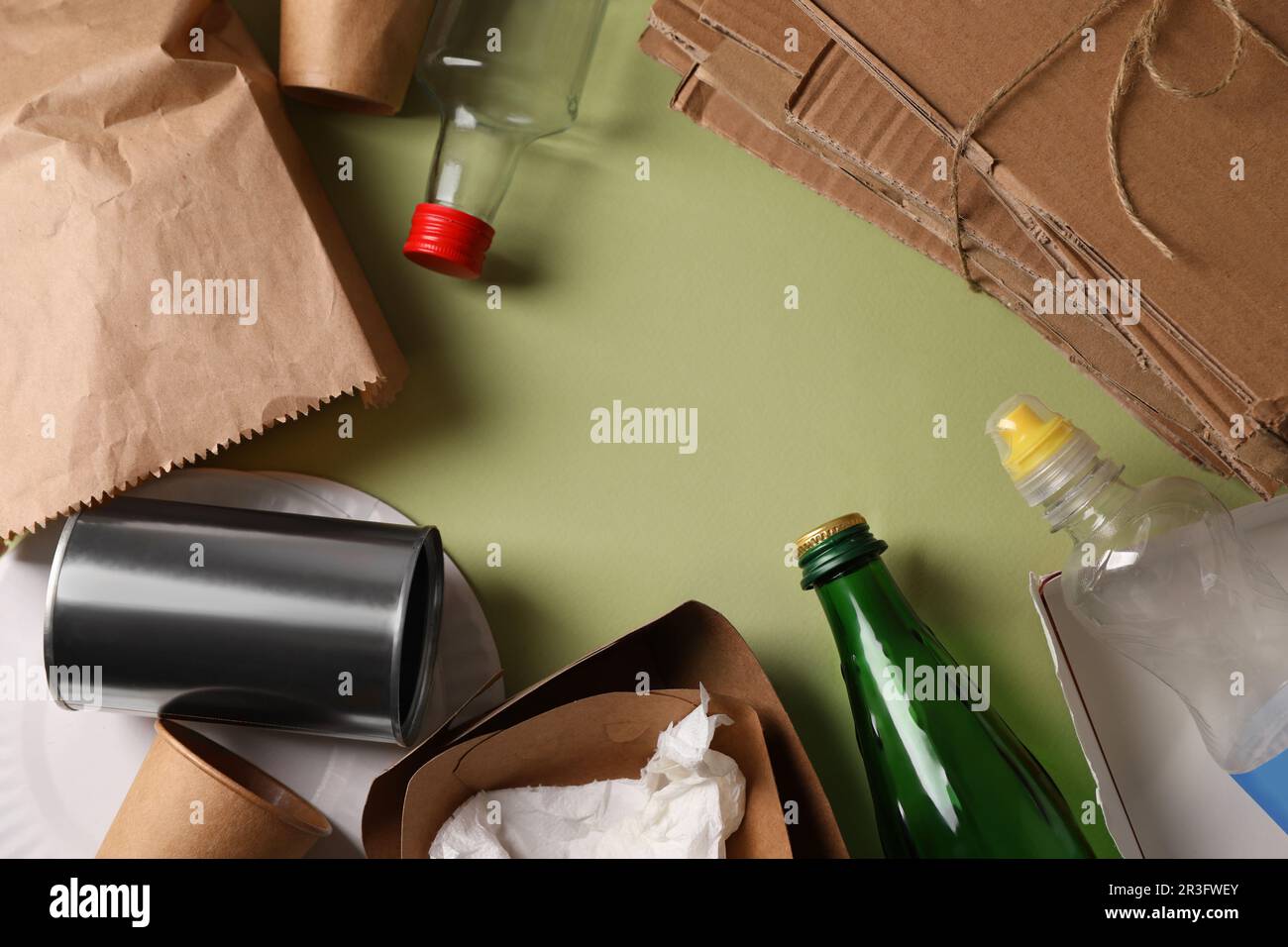 Frame of waste paper and other garbage on pale green background, flat ...