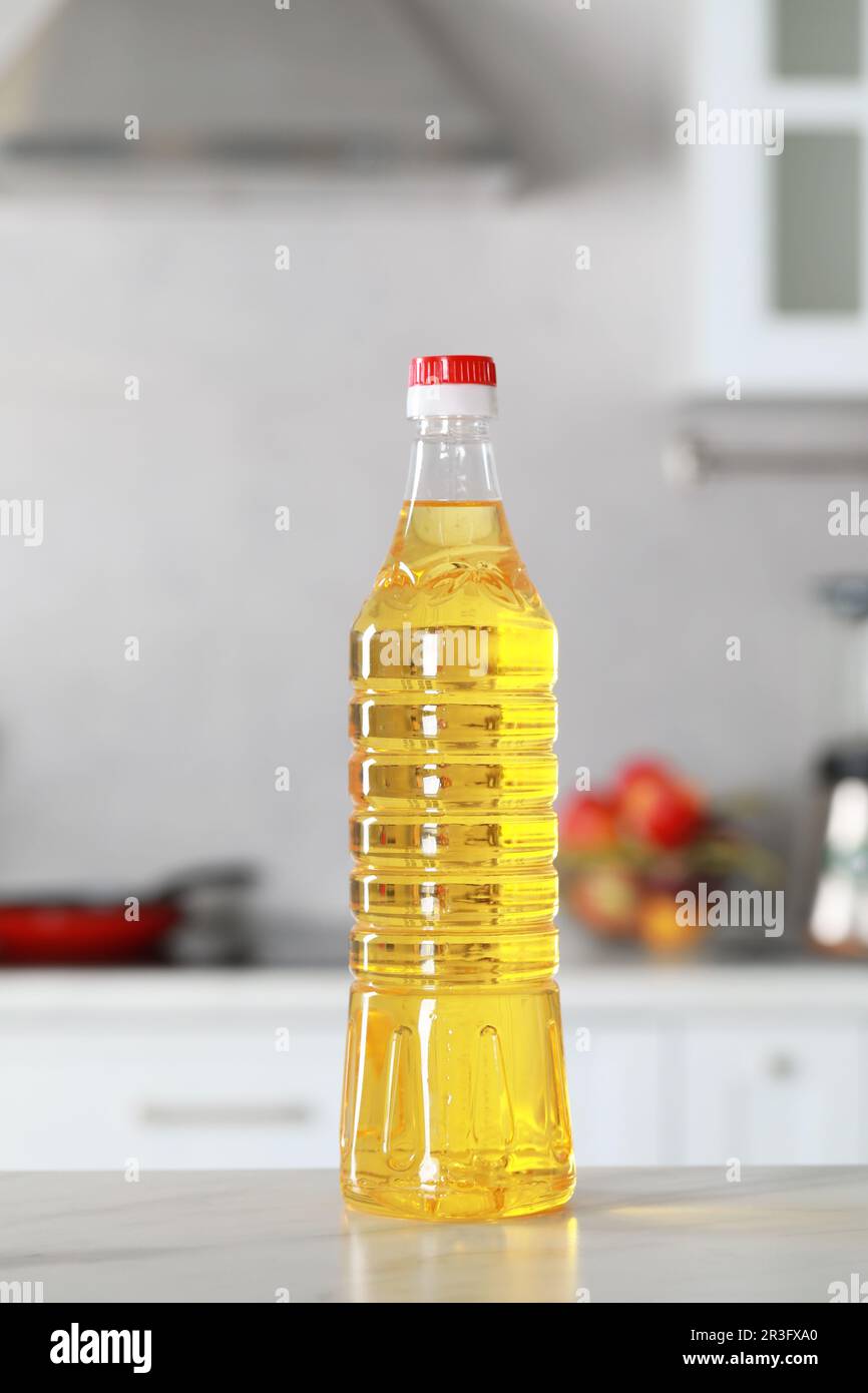 Bottle of cooking oil on white marble table in kitchen Stock Photo - Alamy
