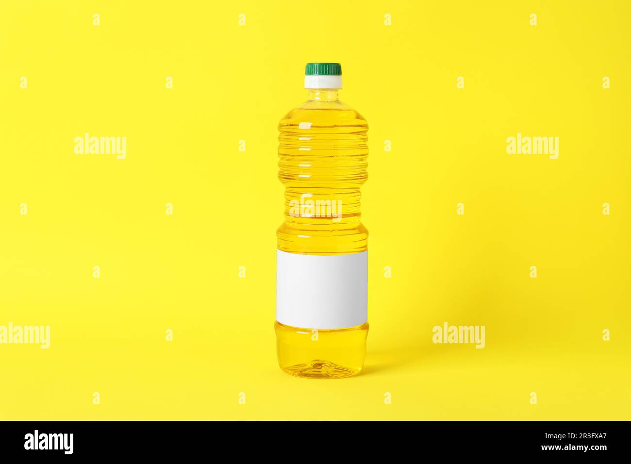 Bottle of cooking oil on yellow background Stock Photo - Alamy