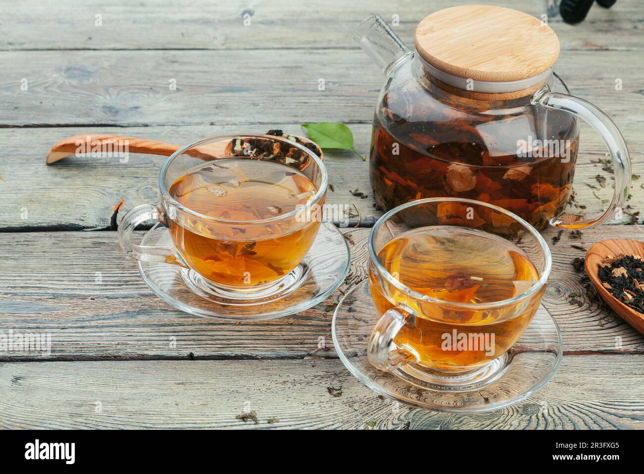 Cup of tea and tea leaves on wooden table Stock Photo - Alamy