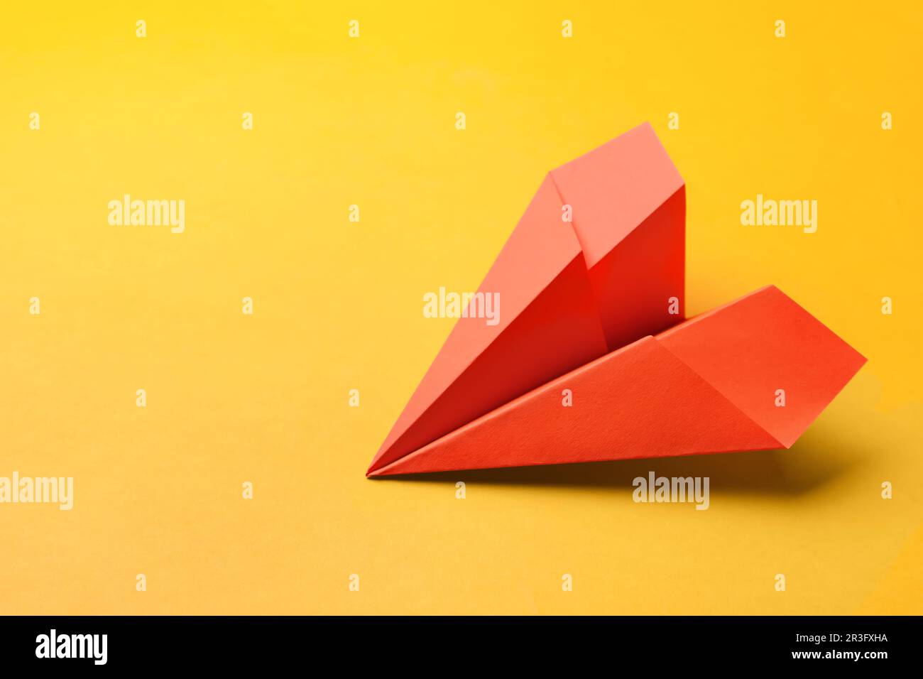 Handmade orange paper plane on yellow background, space for text Stock ...