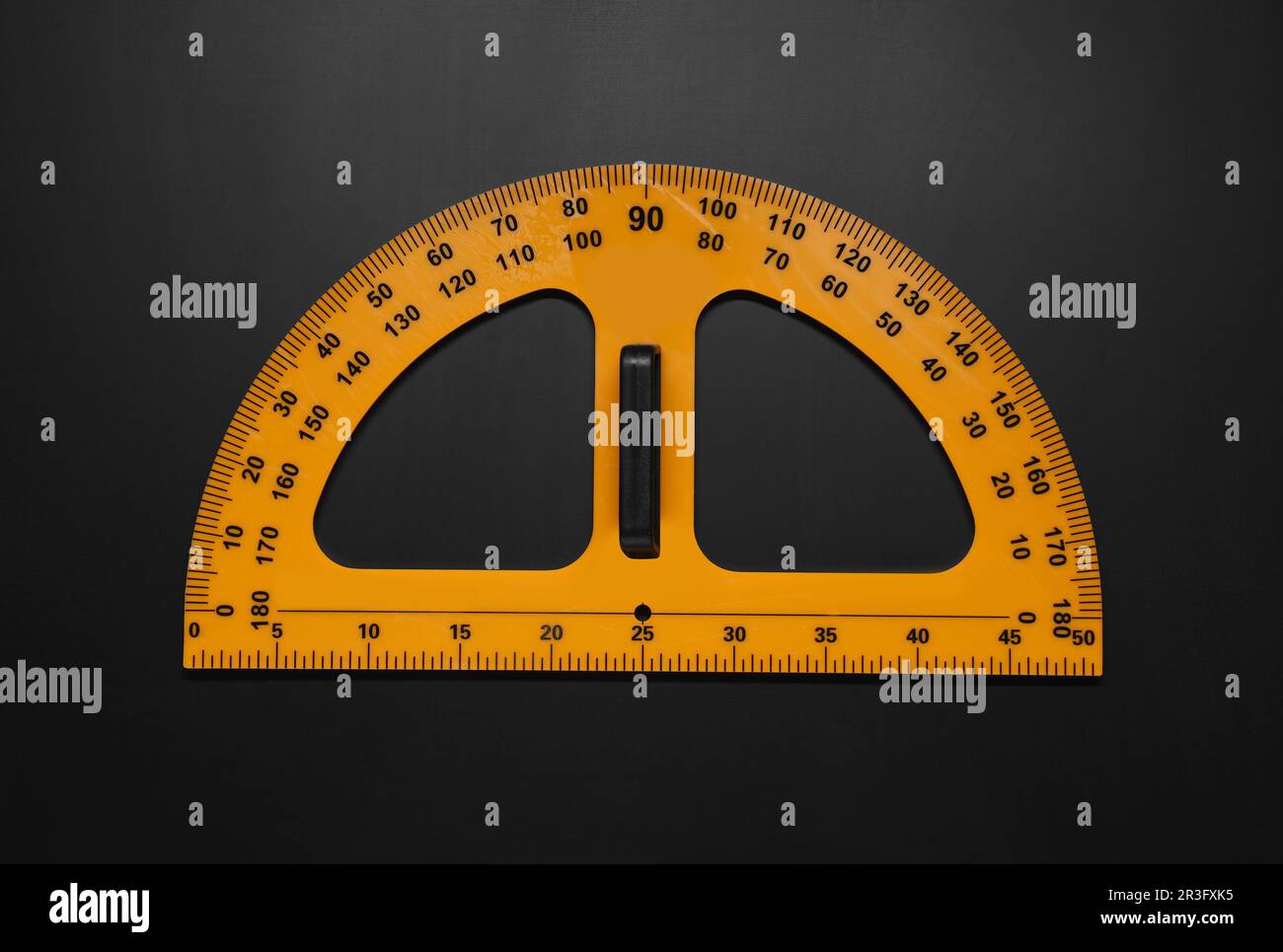 Yellow school protractor on blackboard, top view Stock Photo - Alamy
