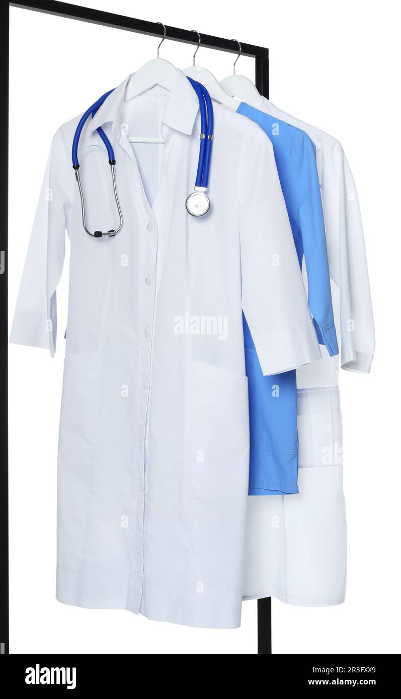 Doctor's gown with stethoscope and different medical uniforms on rack ...