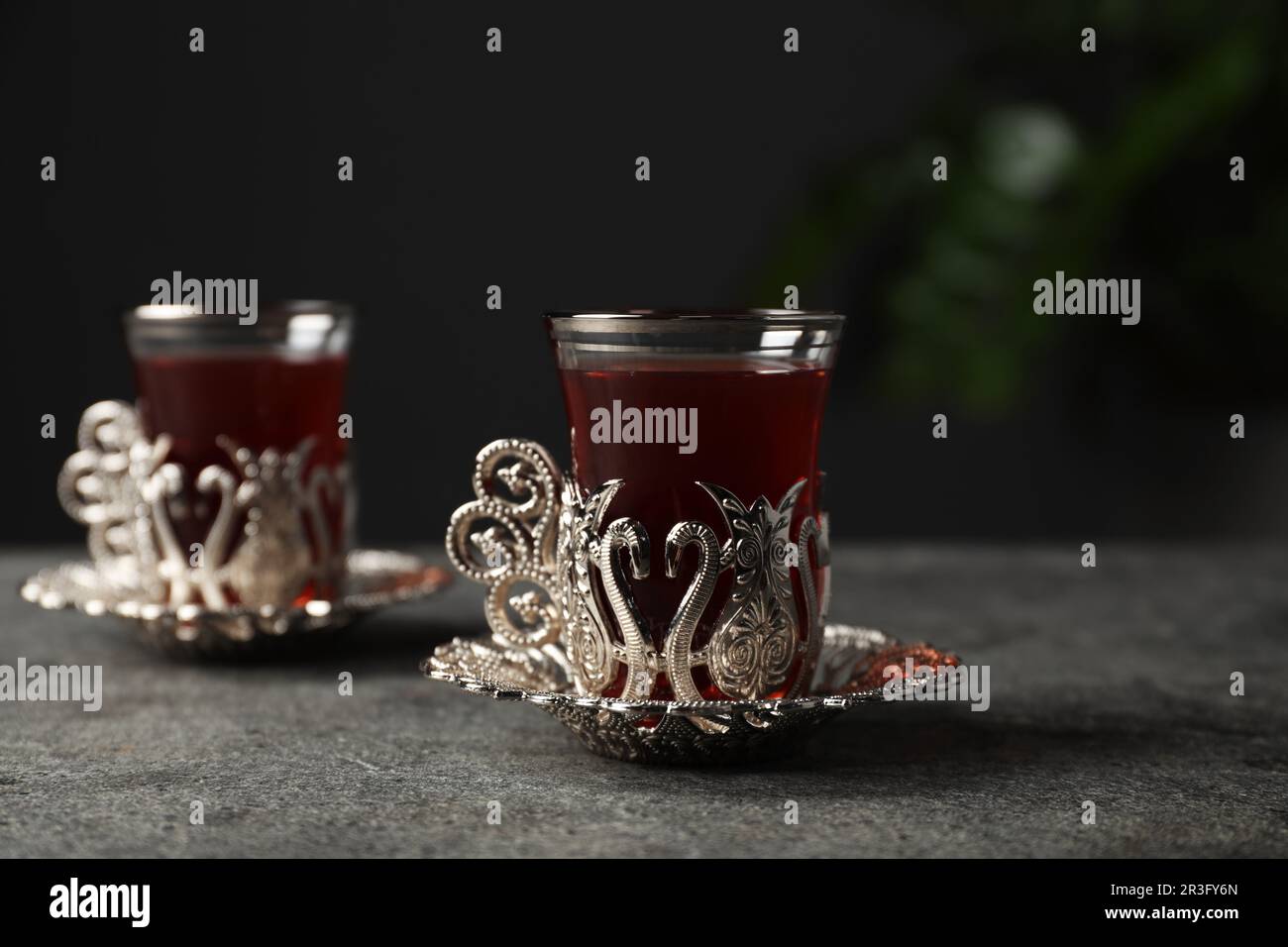 Glass of traditional Turkish tea in vintage holder on grey table Stock ...