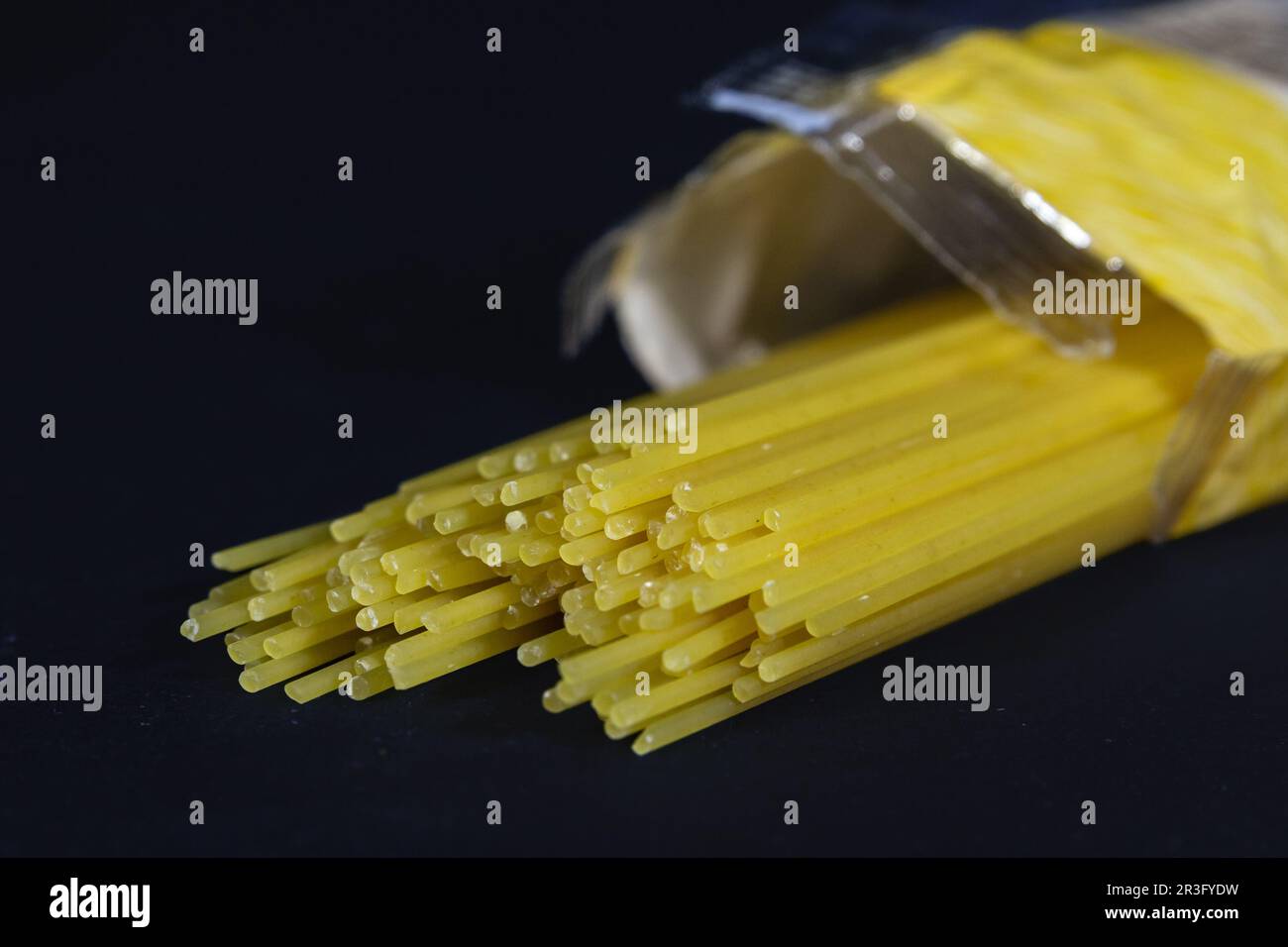 Picture of spaghetti packet, open, isolated on a black background ...