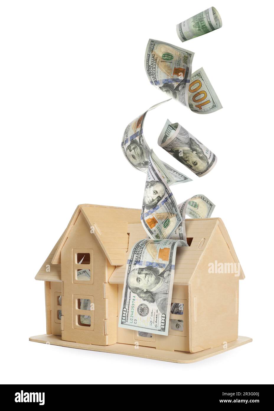 Dollars falling into house shaped money box on white background Stock ...