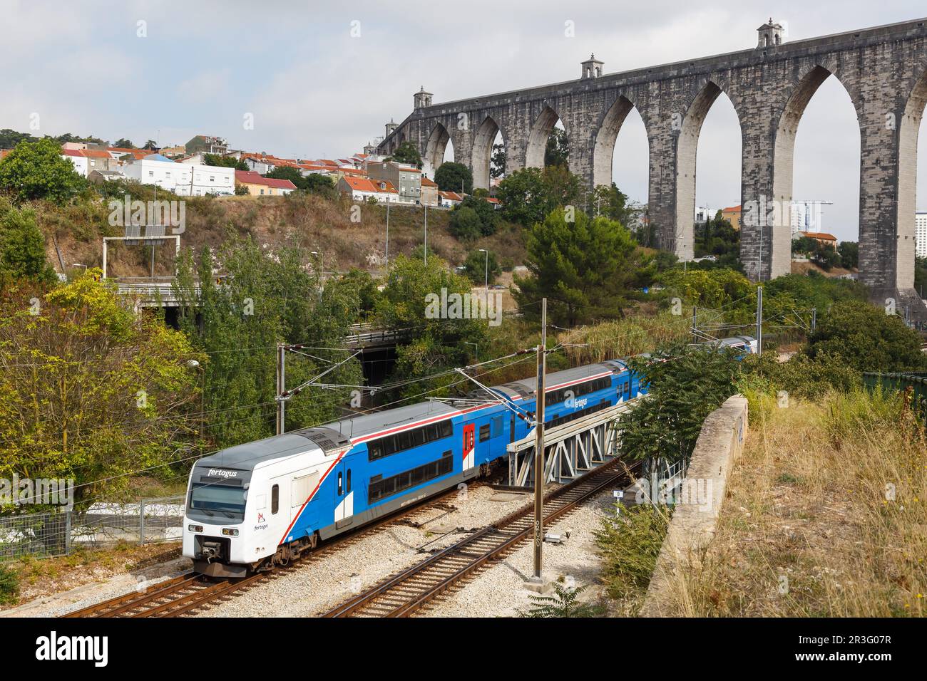 Fertagus train at aqueduct Aqueduto das Aguas Livres railroad in Lisbon ...