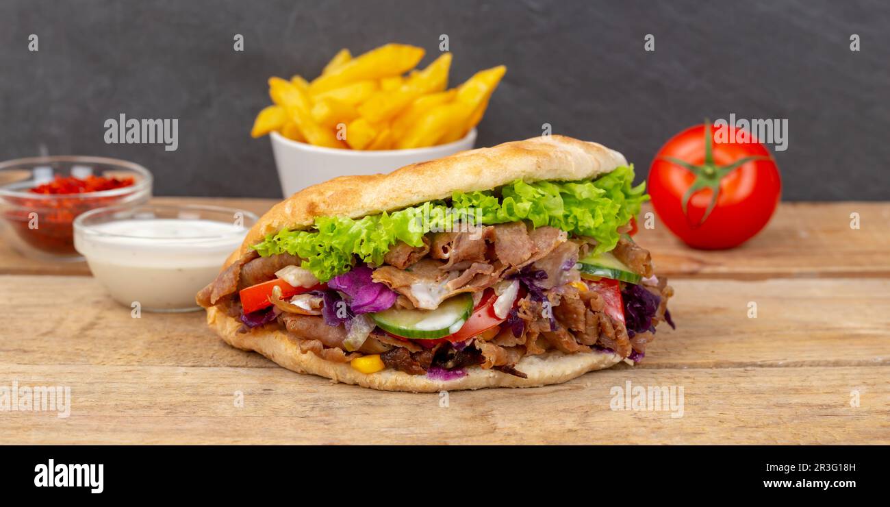 Doner kebab Doner kebap fast food food in pita bread with fries on ...