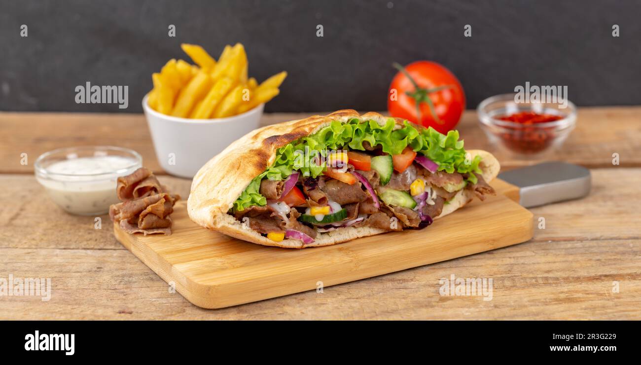 Doner kebab Doner kebab half fast food food in pita bread with fries on ...