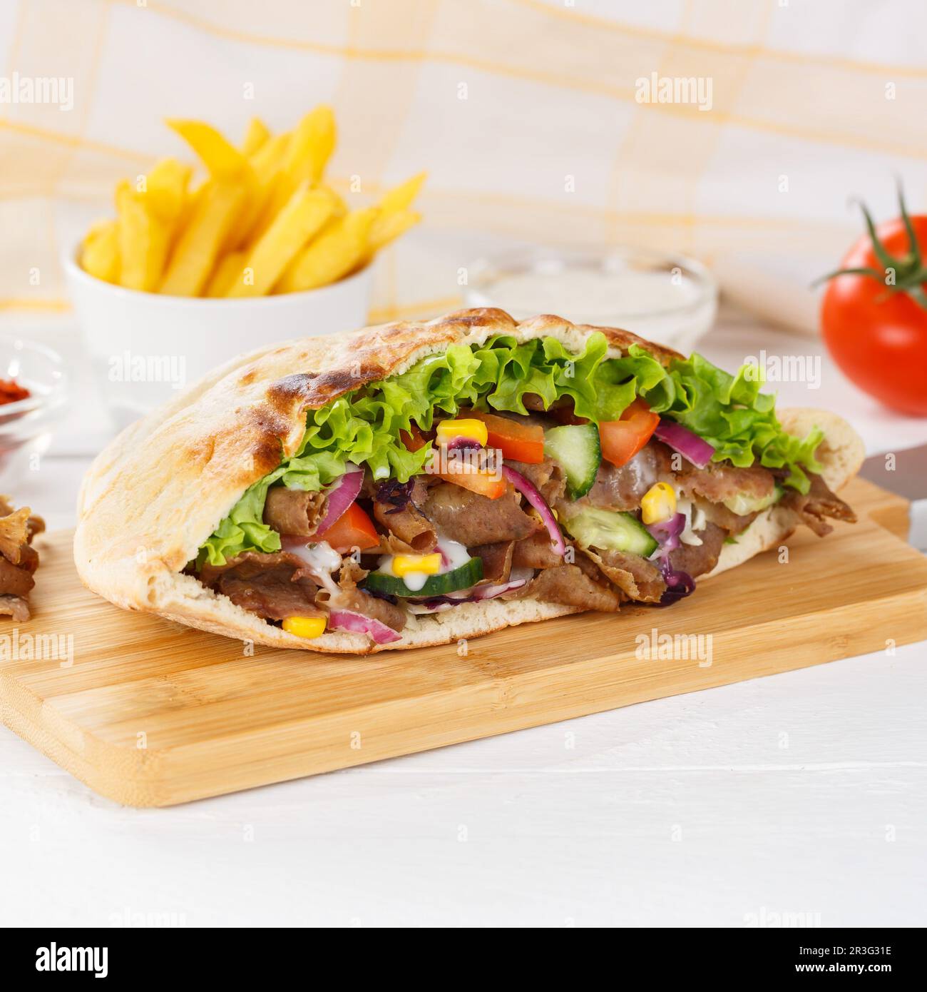 Doner kebab Doner kebab half fast food food in pita bread with fries on ...