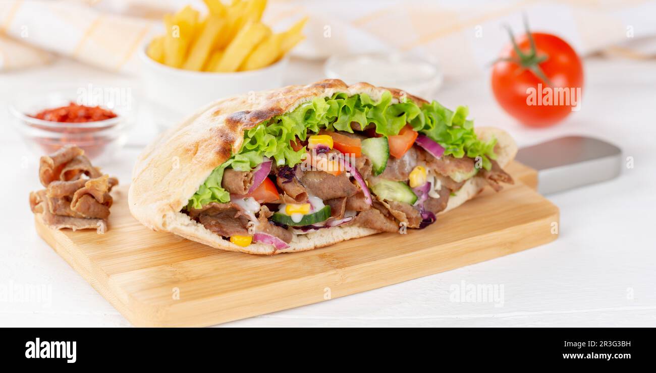Doner kebab Doner kebab half fast food food in pita bread with fries on ...