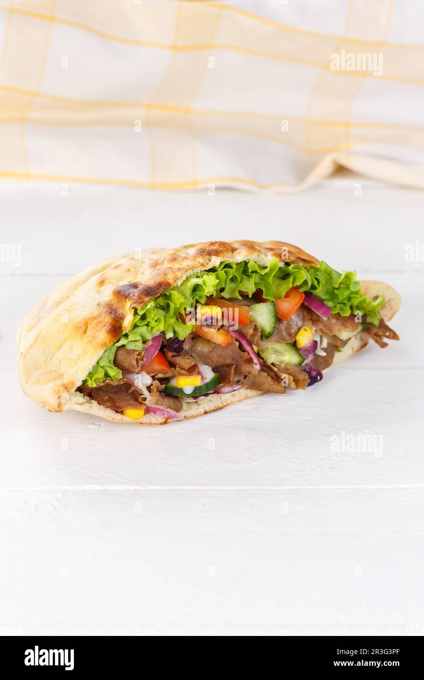 Doner kebab doner kebab half fast food food in pita bread portrait on ...