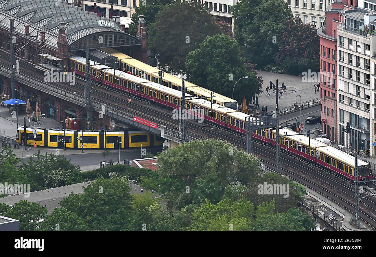 Berlin, Germany. 23rd May, 2023. Two trains meet while a tram runs under them in downtown Berlin ...