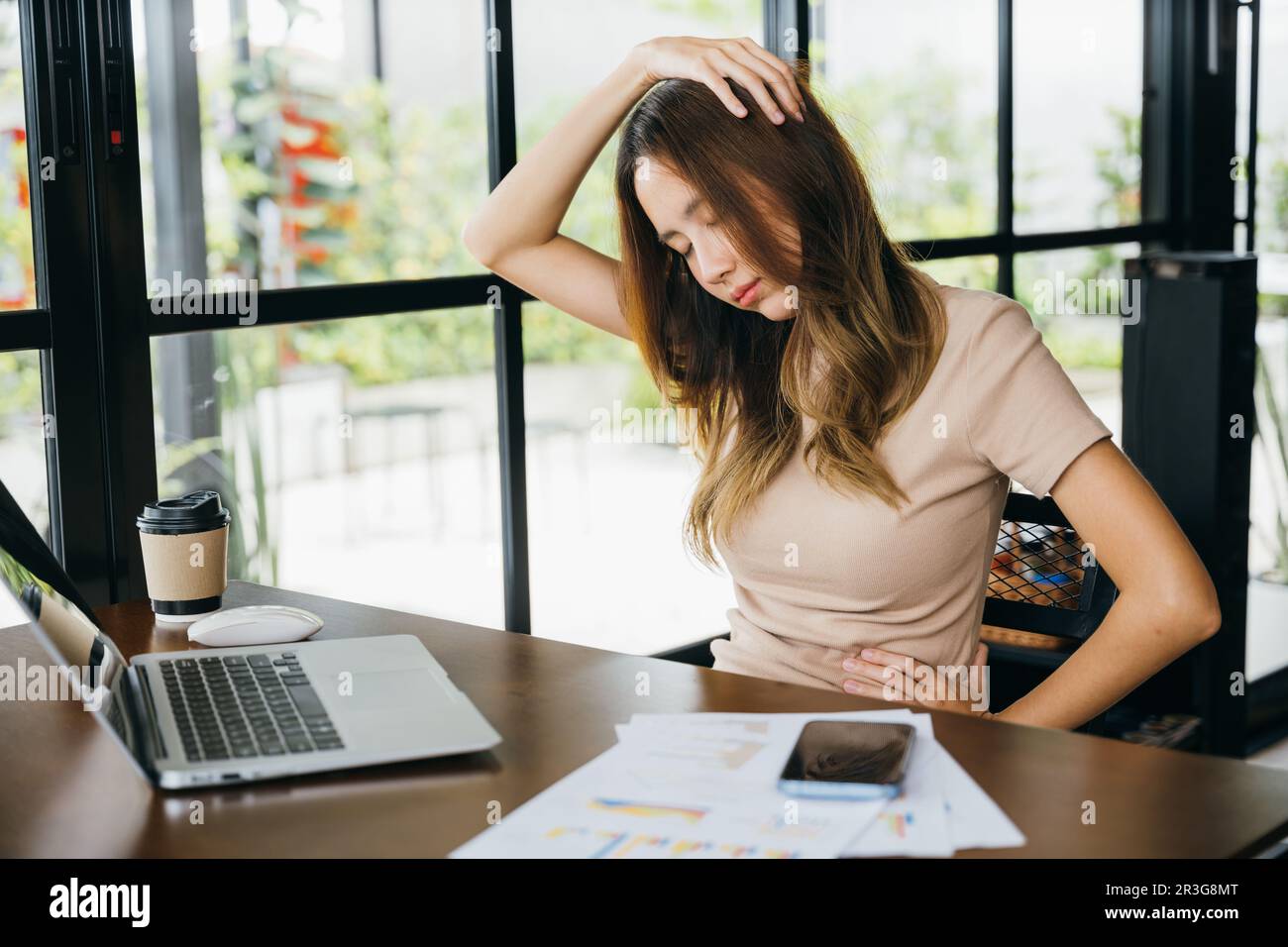Businesswoman freelance suffering from neck ache pain caused by long ...