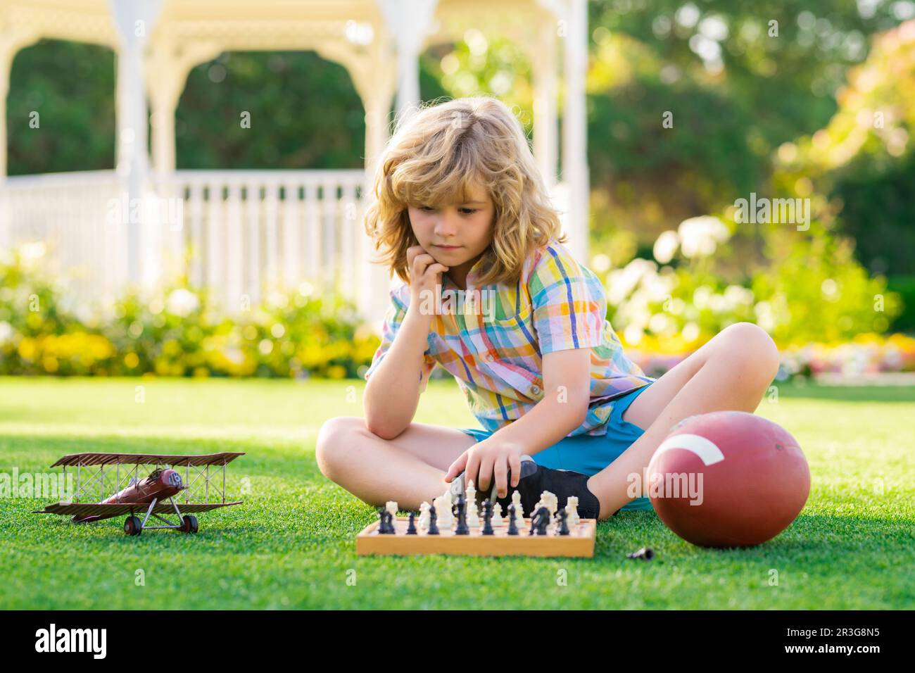 Dream kids and childhood concept. Kid laying on grass enjoy summer ...
