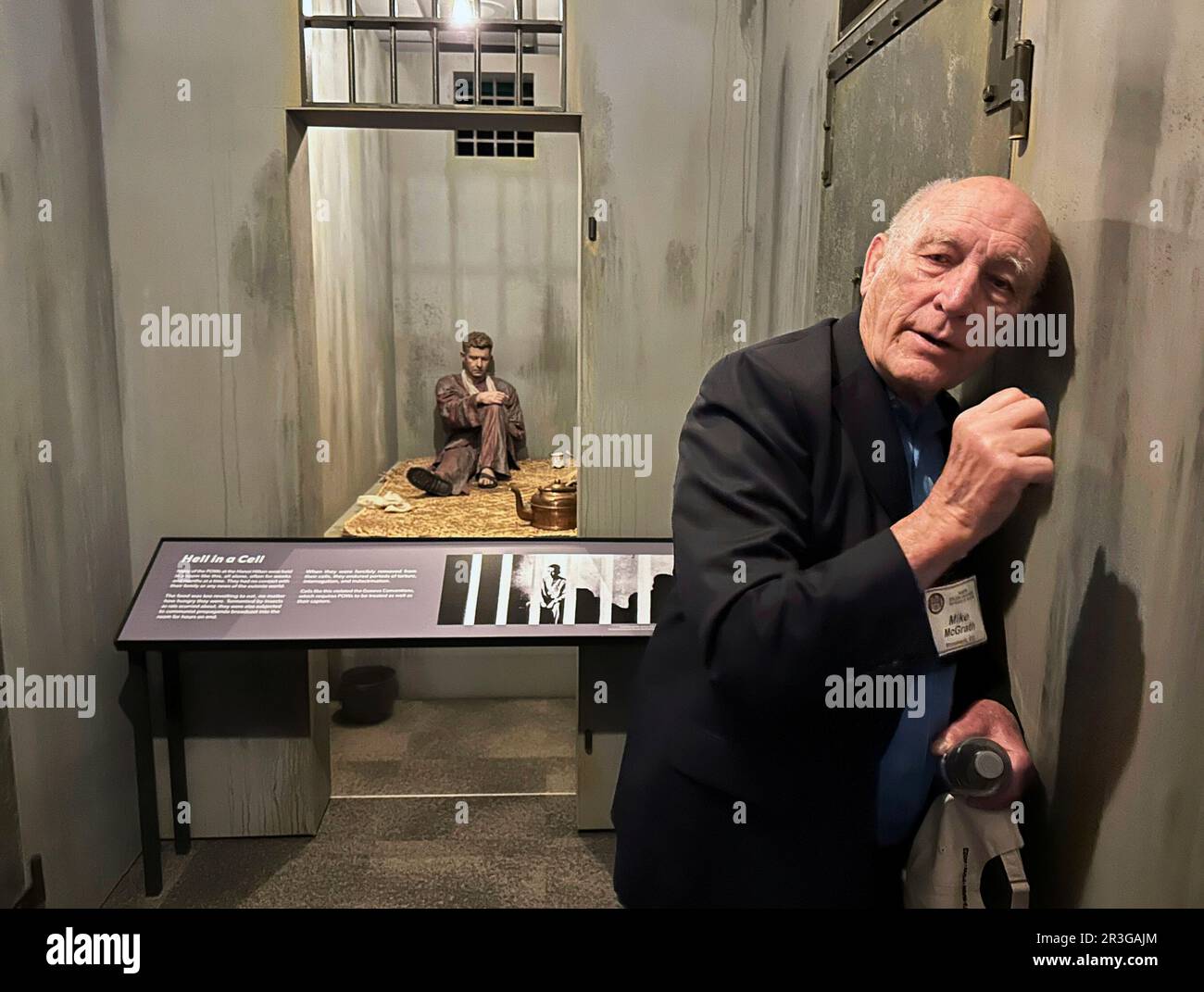POW Mike McGrath demonstrates how prisoners tapped on the wall to ...