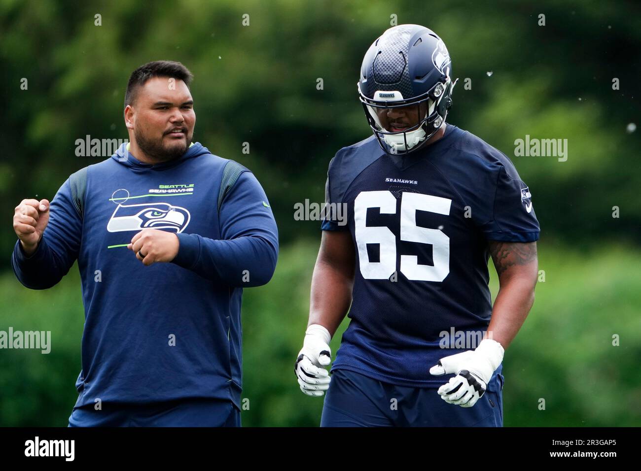 Assistant offensive line coach Keli'i Kekuewa talks with Seattle ...