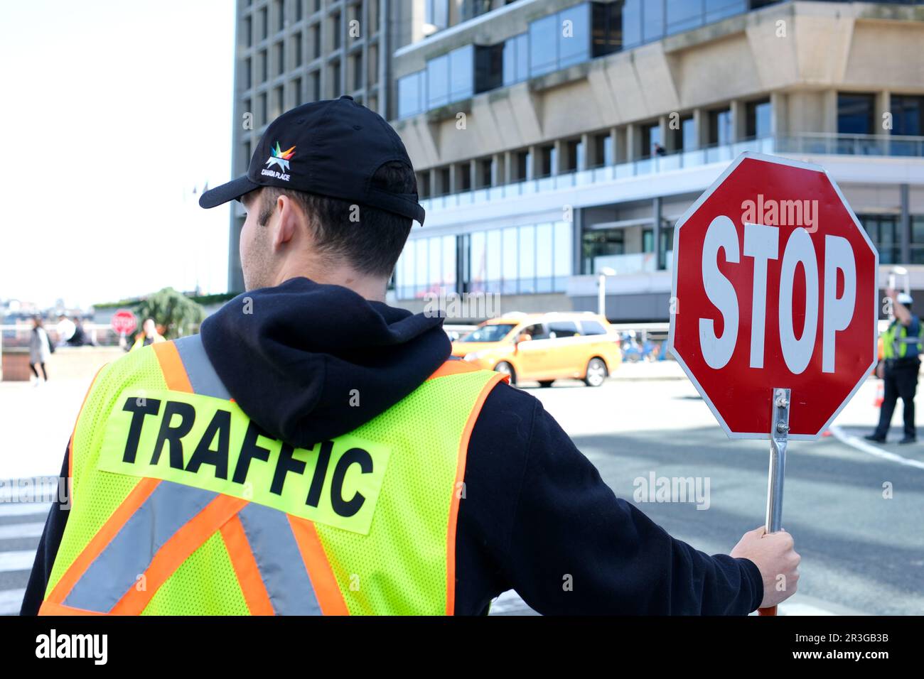 A construction road worker stopping traffic, holding a stop sign ...