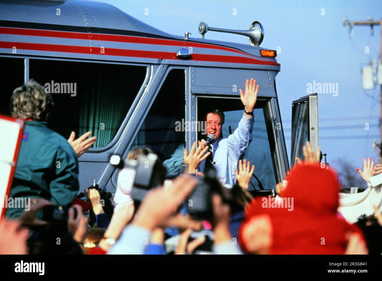President William Clinton waves from bus on his trip into Washington ...
