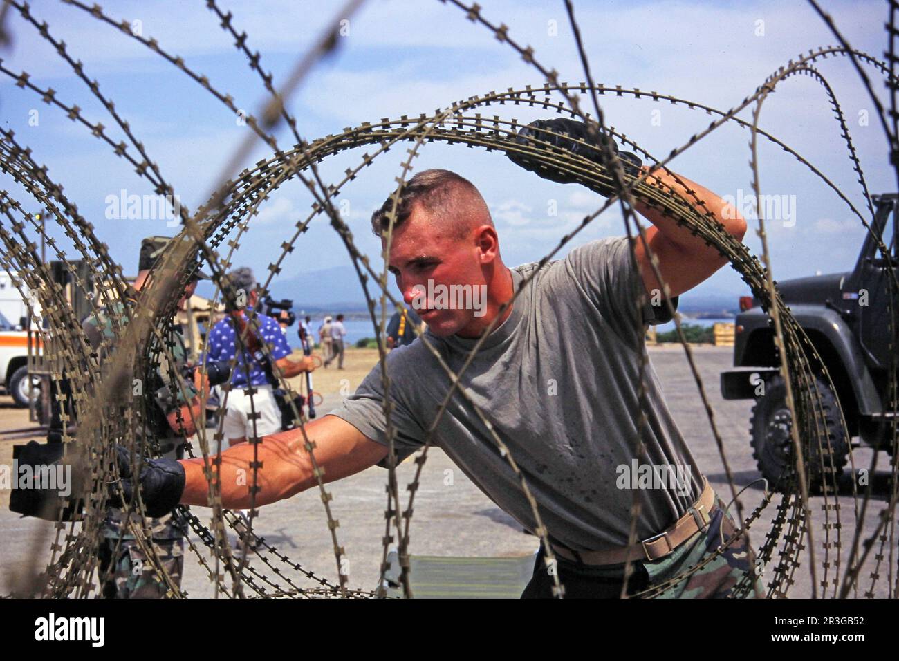 A Marine helping construct a fencee at the Guantanamo Bay refugee camp ...
