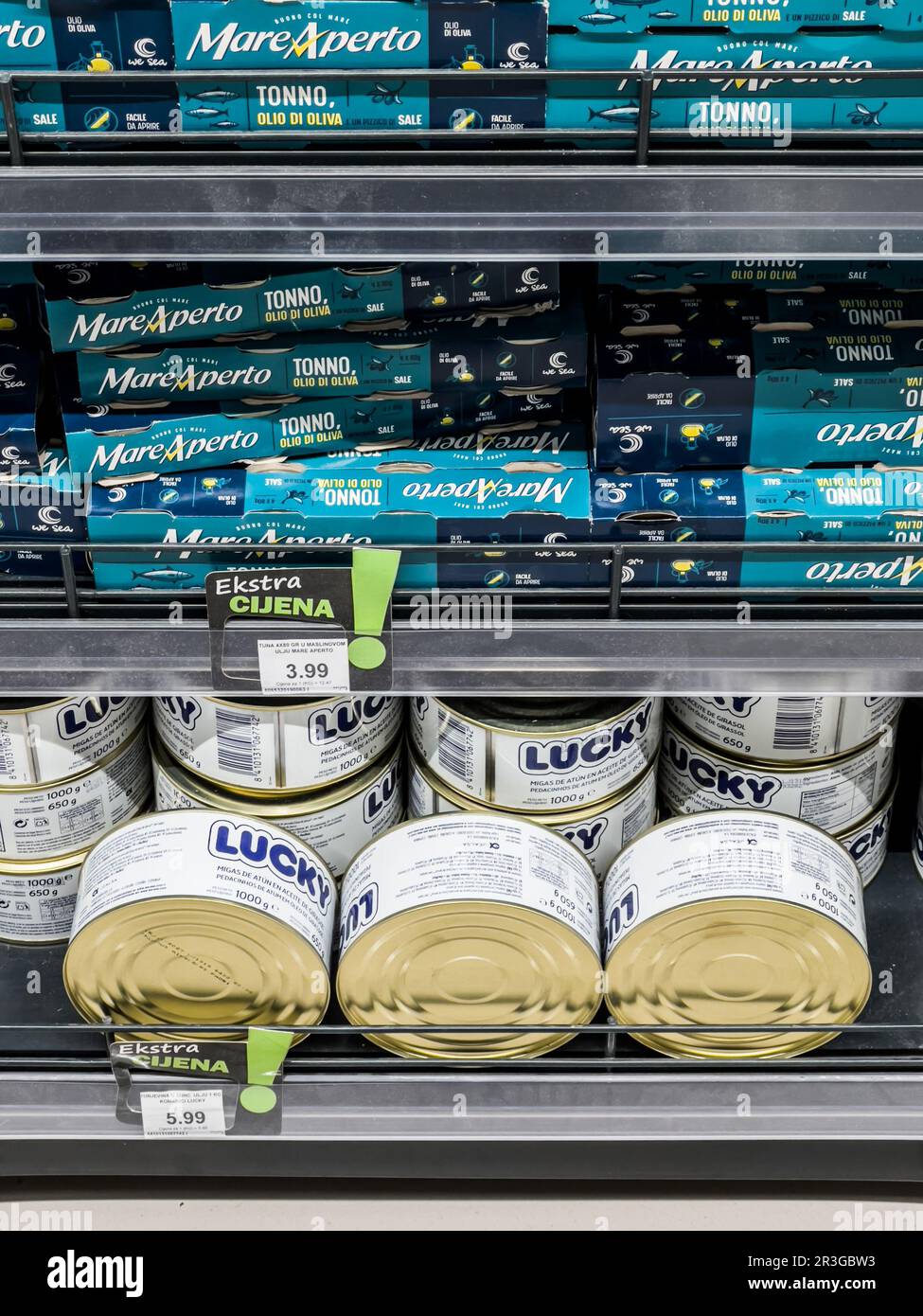 Metal cans with canned fish lie on the shelves in the store Stock Photo ...