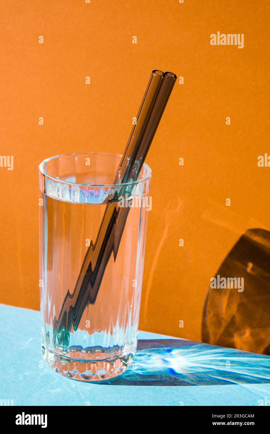 Reusable Glass Straws In Glass With Water On Colorful Background Eco