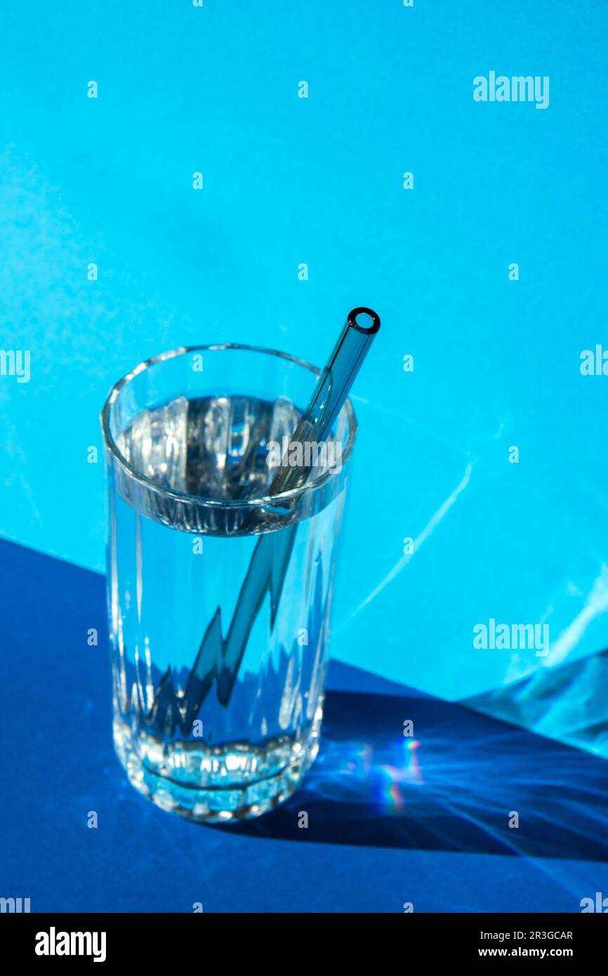 Reusable glass Straws in Glass with water on blue background Eco ...