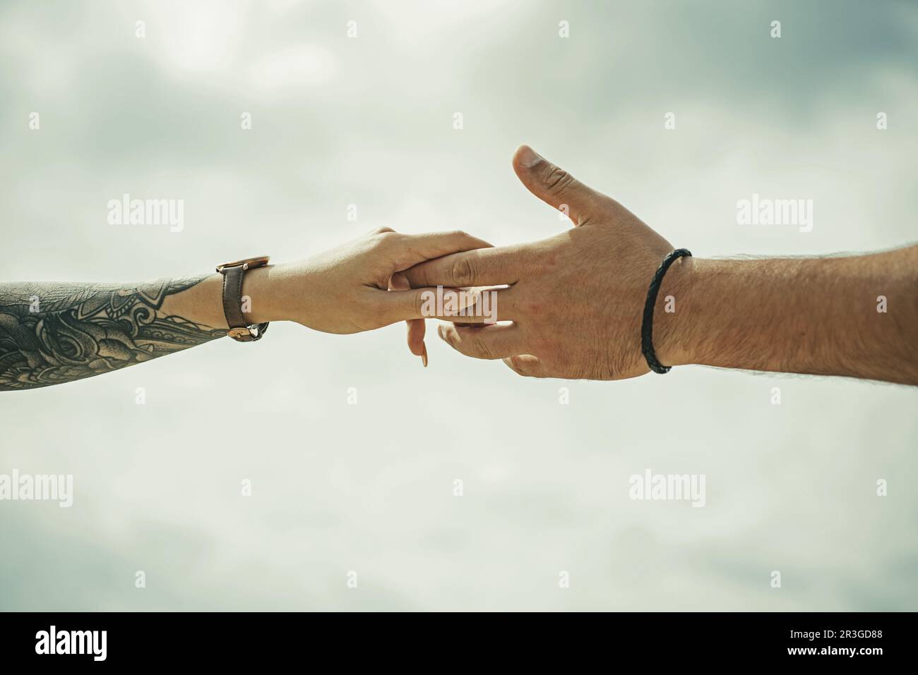 Couple hands with tattoo. Helping hand. Holding hand, close up. Giving ...