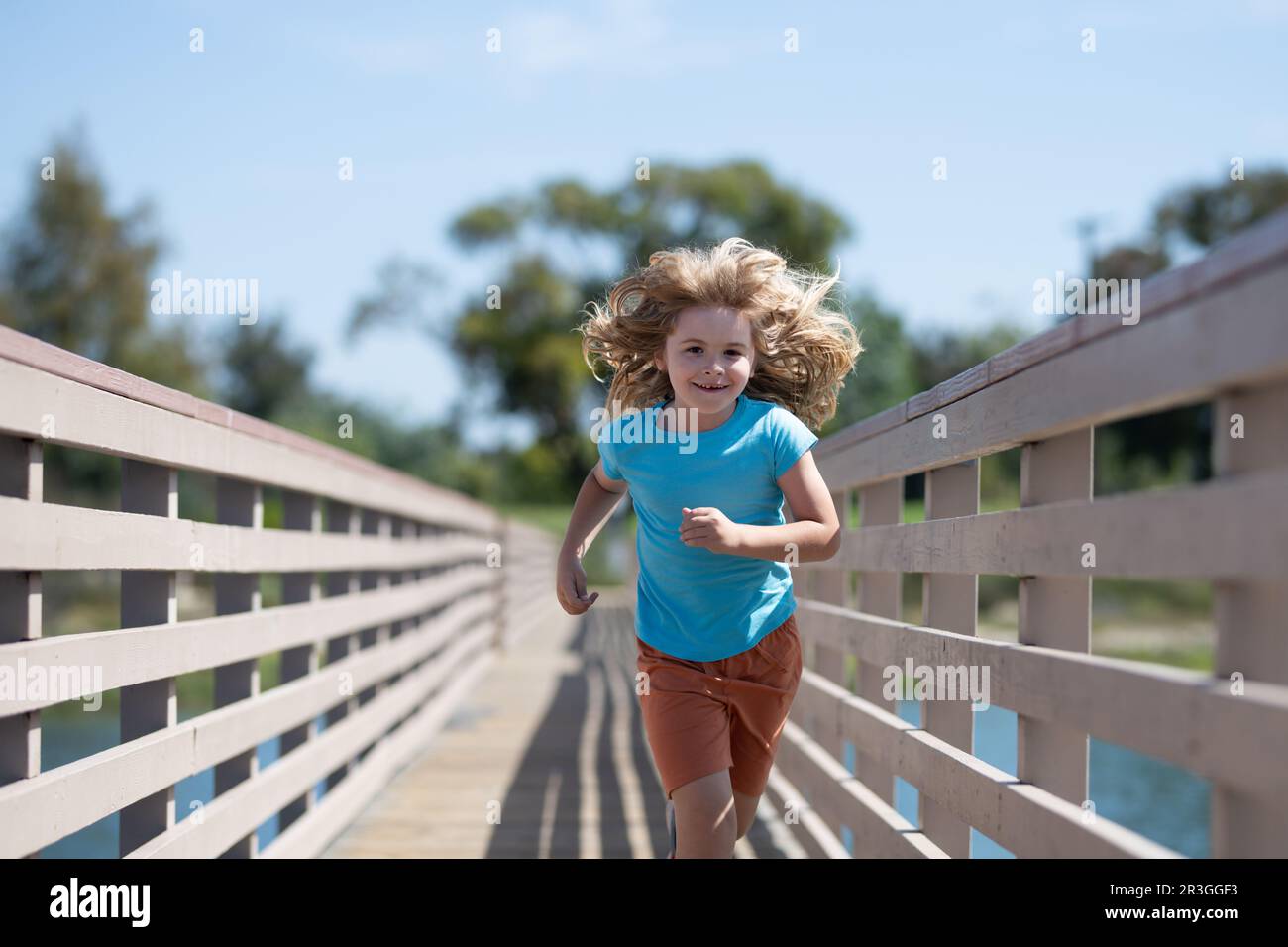 Sporty kid running in nature. Active healthy child boy runner run ...