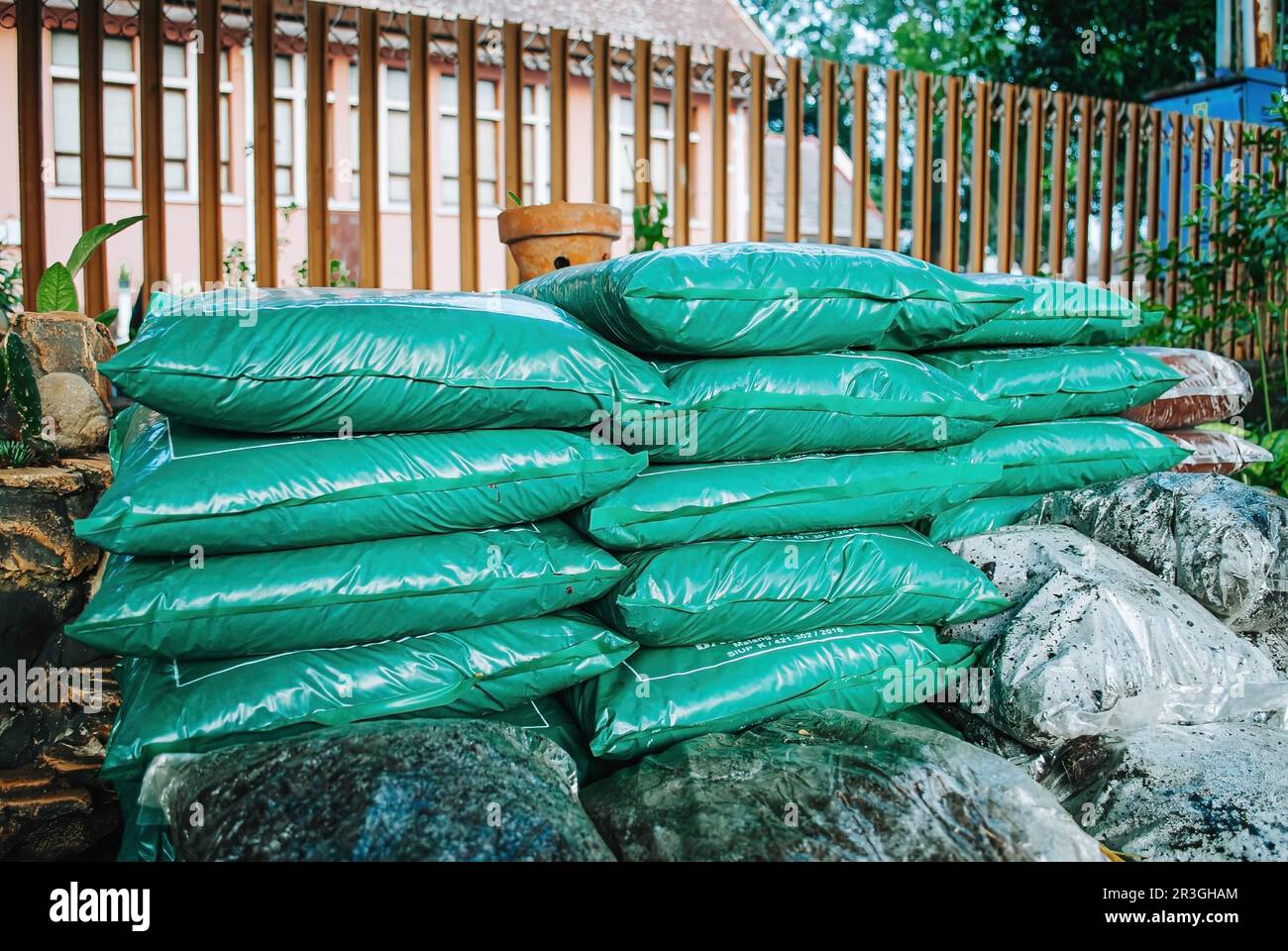 Stacks of organic fertilizers packaged in turquoise blue reusable ...