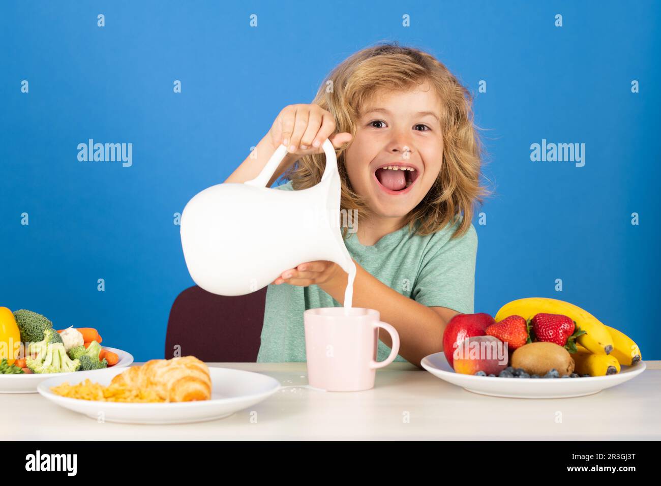 Excited kid with dairy milk. Healthy child pours milk from jug Stock ...