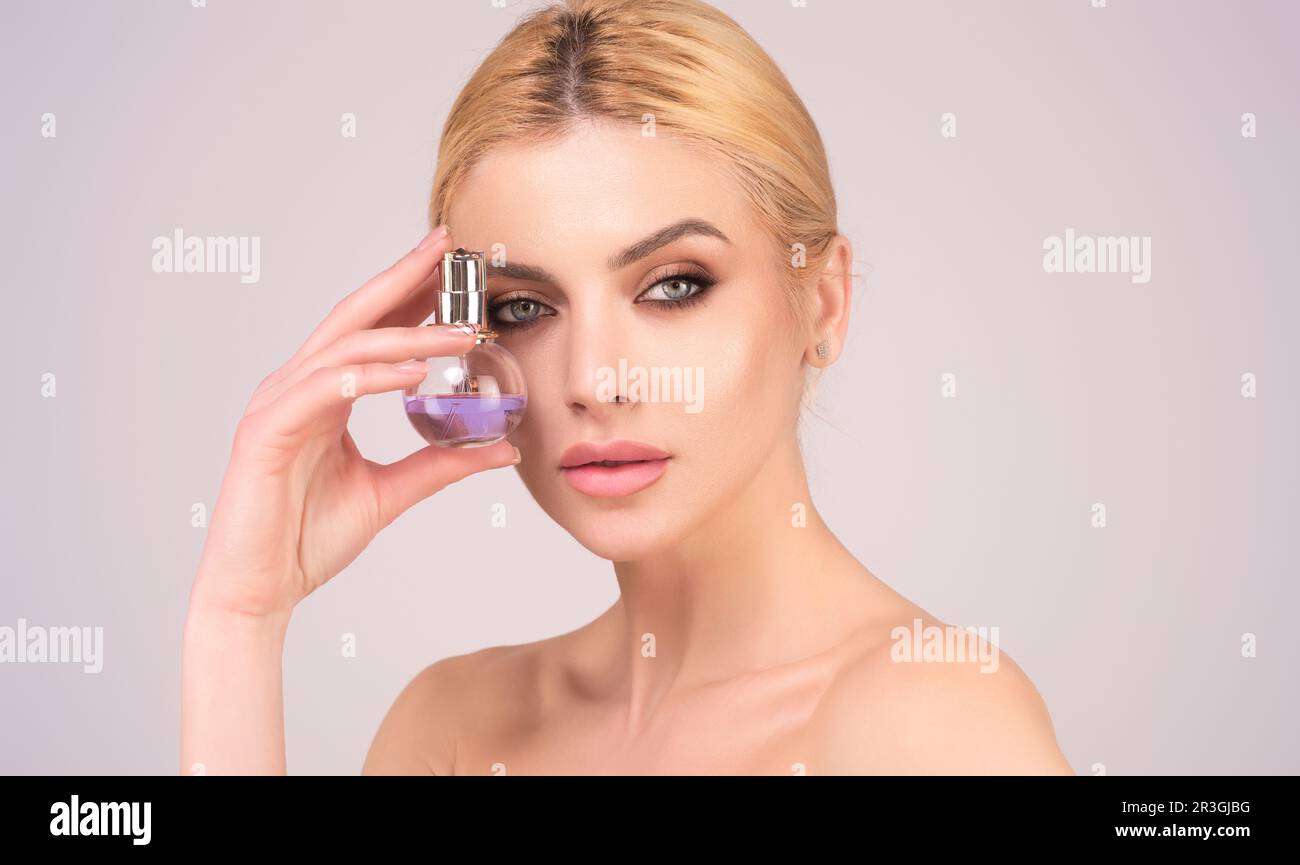 Beautiful romantic tender girl using perfume. Woman with bottle of ...