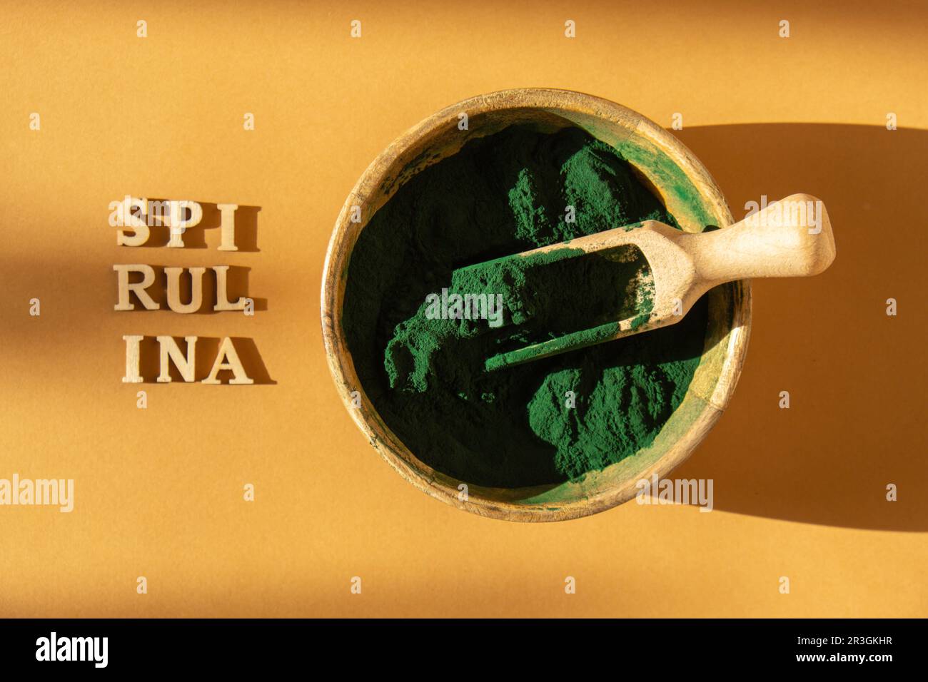 Blue-green algae spirulina powder in bamboo eco bowl with text ...