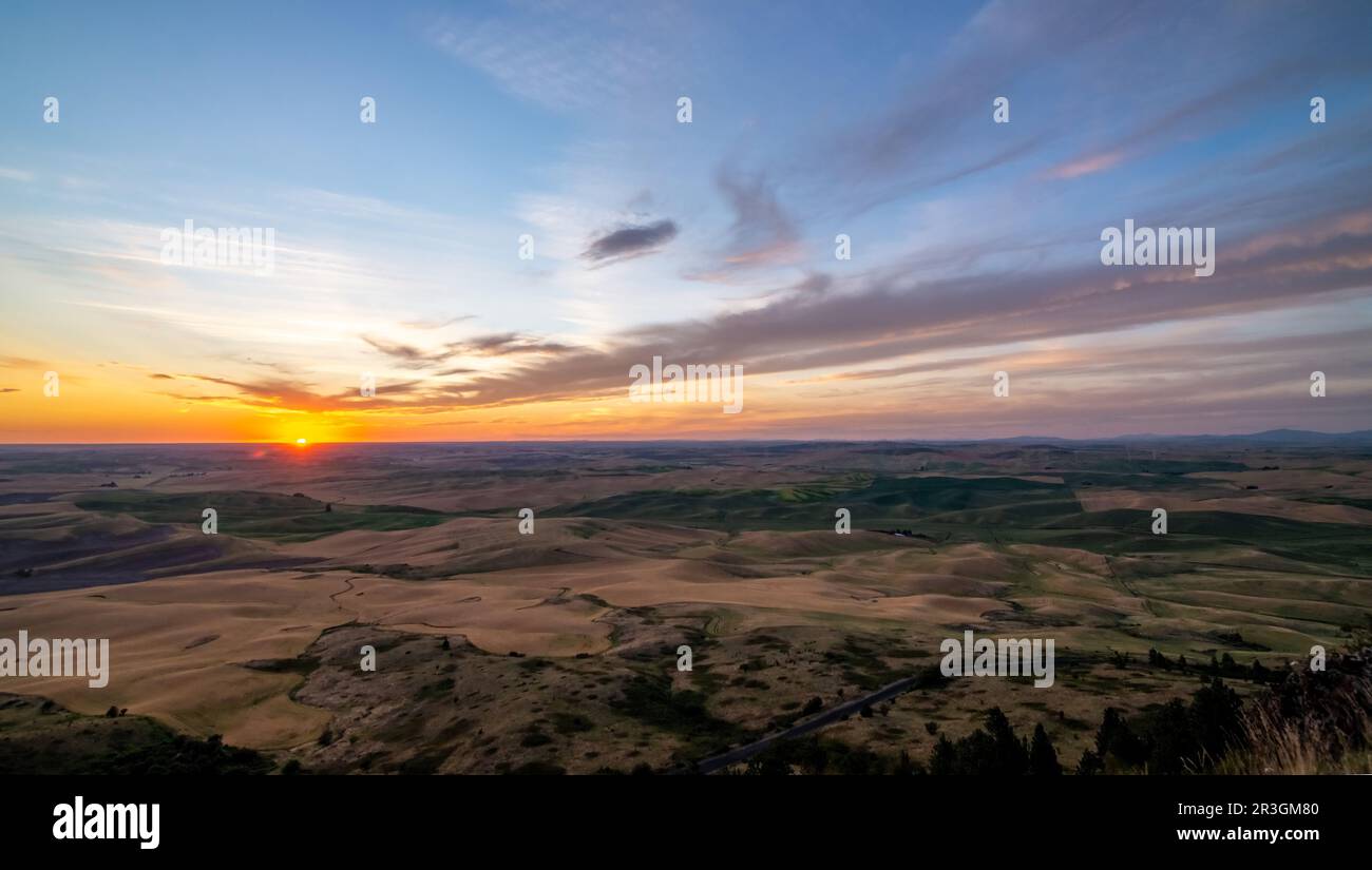 Sun setting below the horizon in a loose region of eastern Washington ...