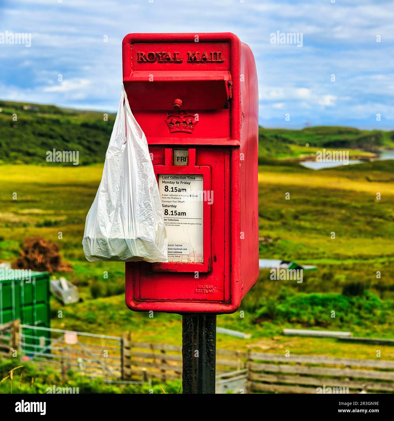 Fresh eggs, egg carton in a plastic bag, hanging on red letterbox with ...