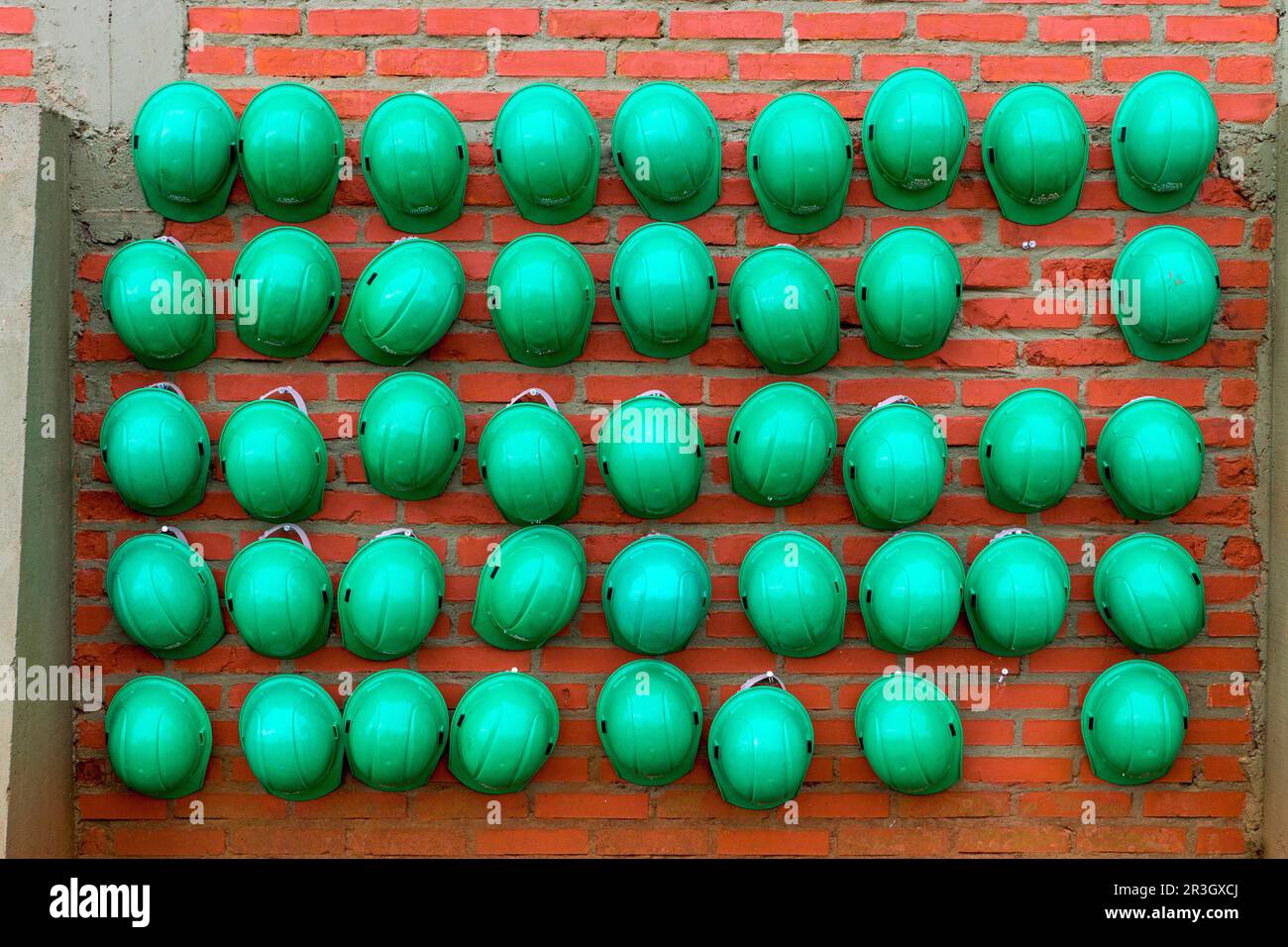 Many green safety helmets Stock Photo - Alamy