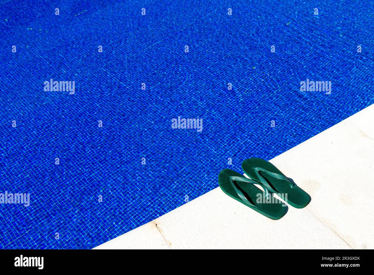Deep blue swimming pool with bathing shoes Stock Photo - Alamy