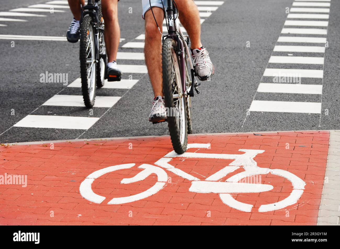 Bicycle road sign and bike riders Stock Photo - Alamy