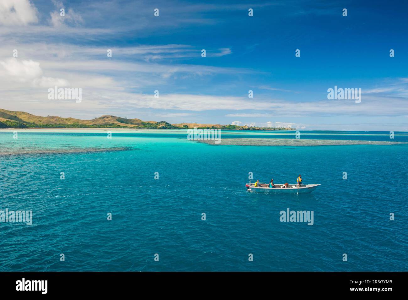 Little boat in the blue lagoon, Yasawas, Fiji, South Pacific Stock ...
