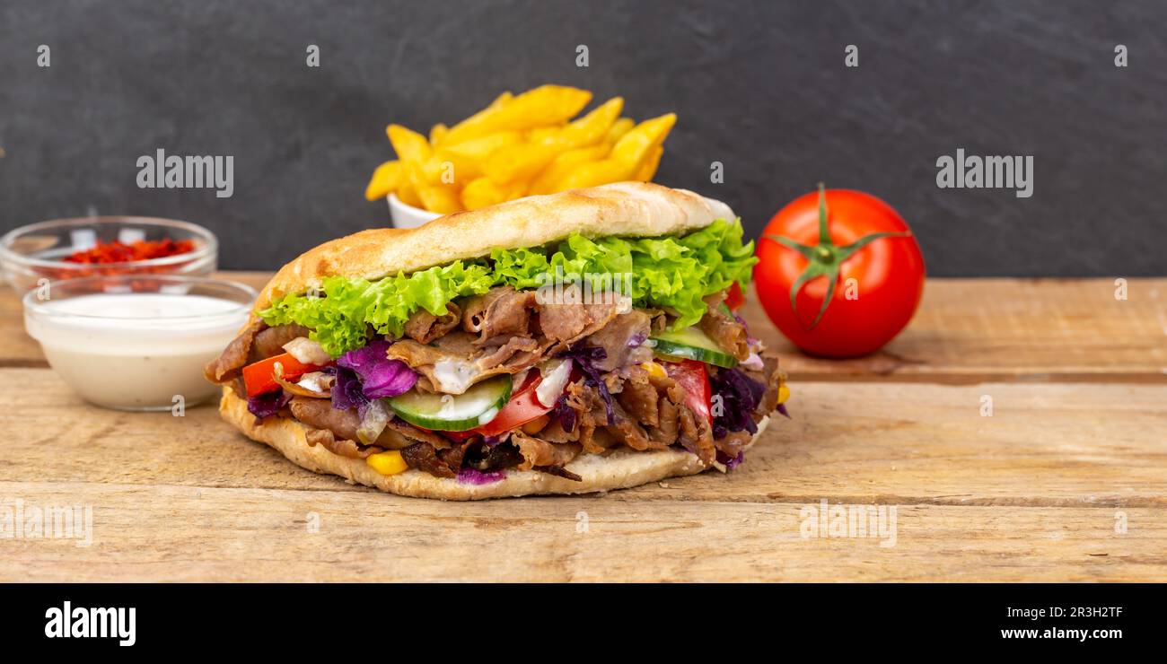 Doner kebab Doner kebap fast food meal in pita bread menu with fries ...