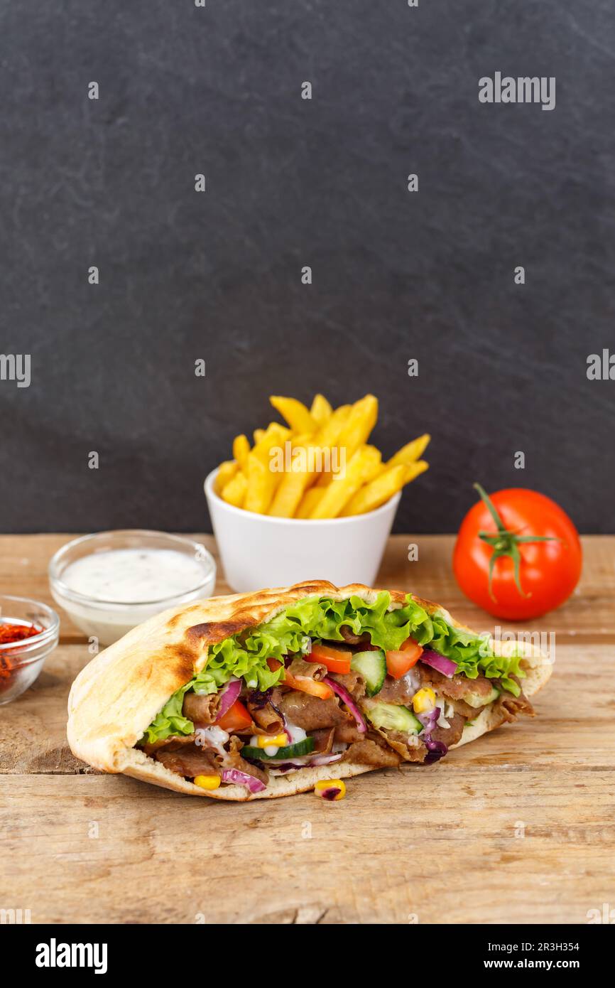 Doner Kebab Doner Kebap fast food meal in pita bread menu with fries on ...