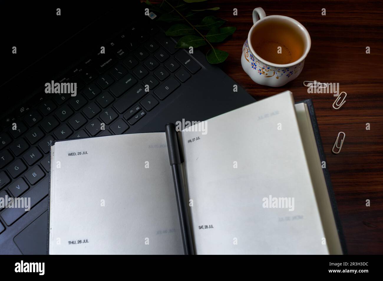 Flat lay design of work desk with teacup, notebook, pen, paper clips ...
