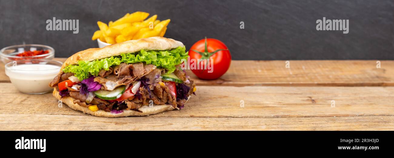 Doner kebab Doner kebap fast food meal in pita bread menu with fries on ...